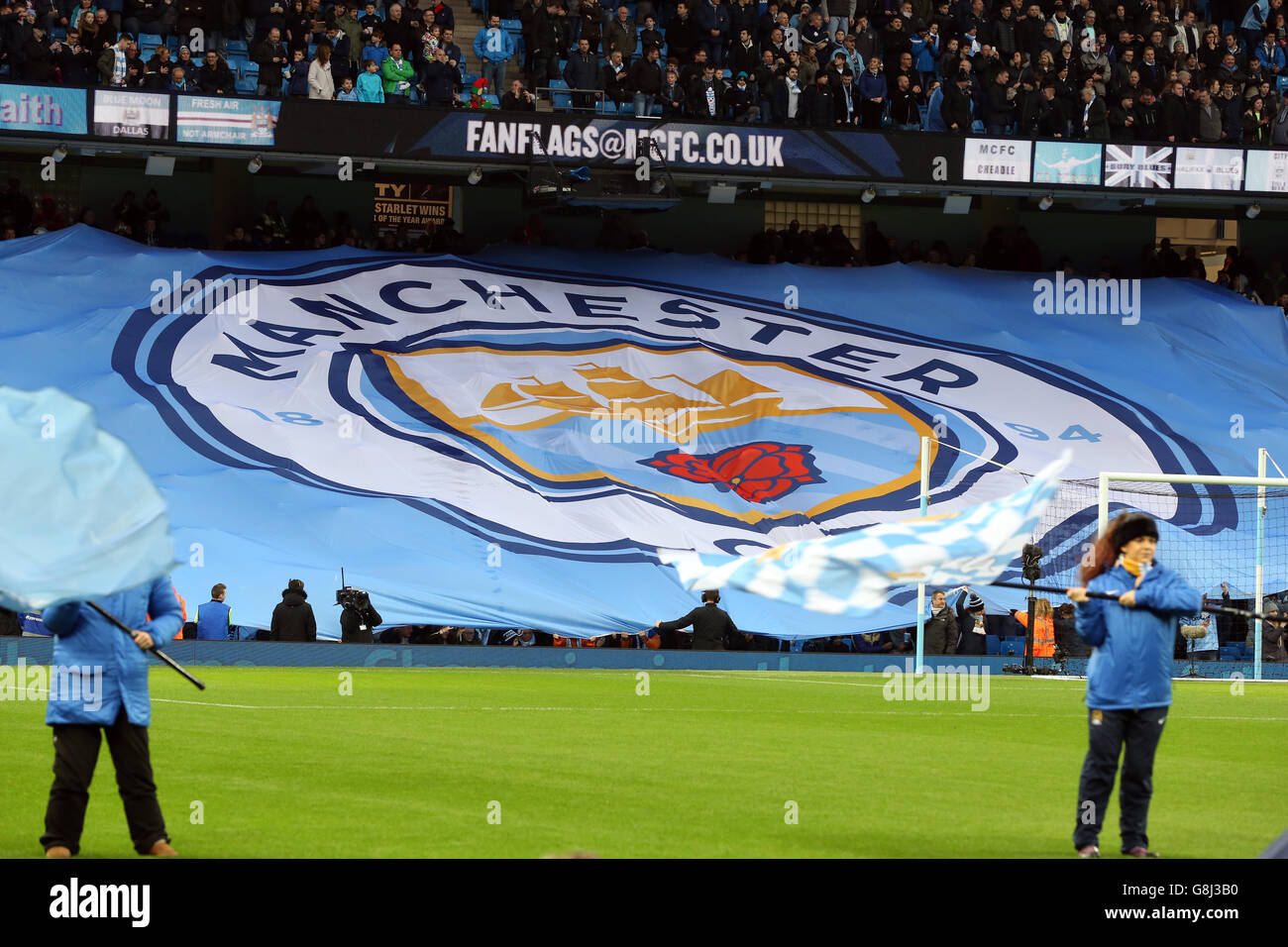 Manchester City fans under a giant flag of their new club crest during ...