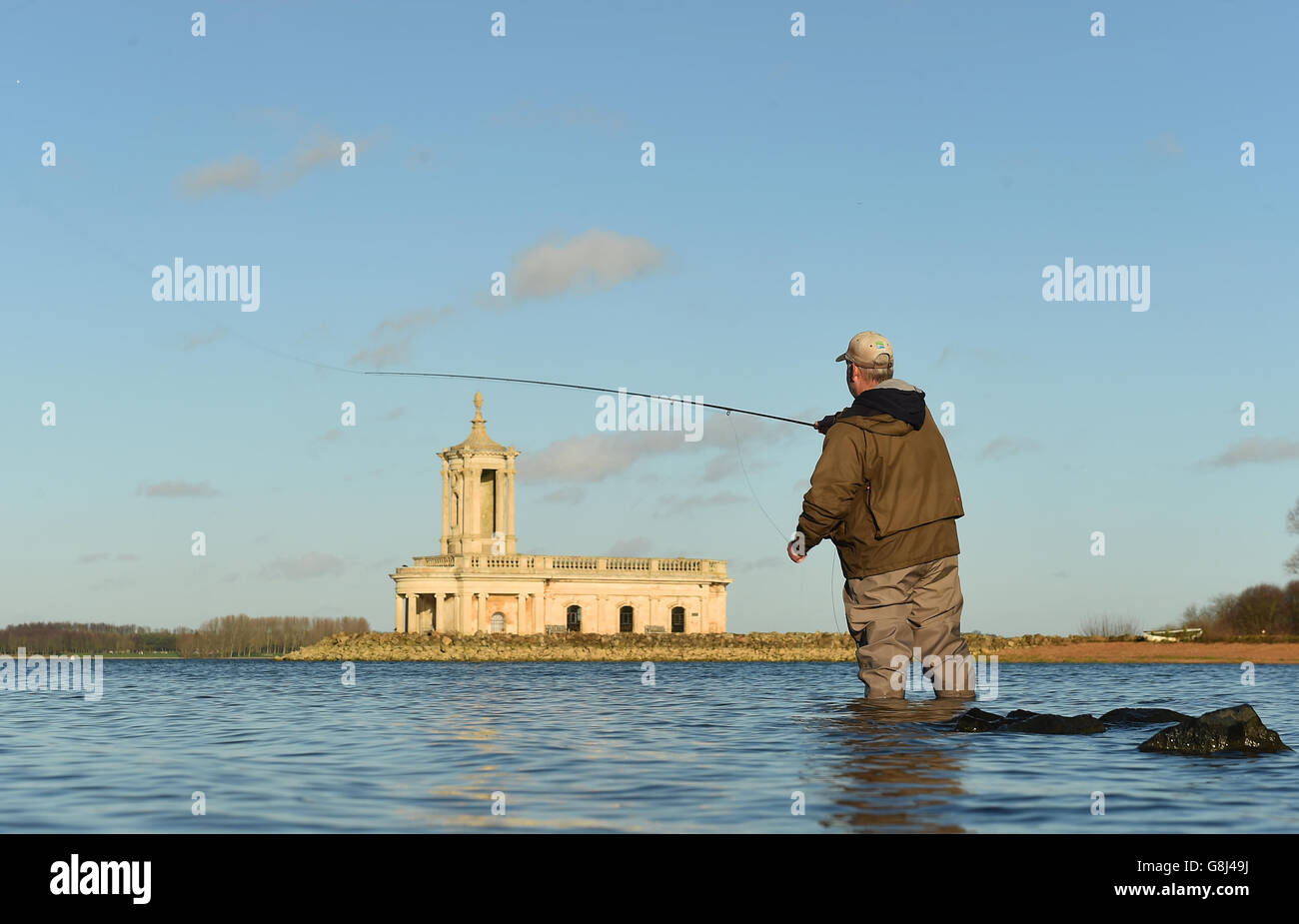 Angler Ade Naylor fishing in front of Normanton Church at Rutland Water ...