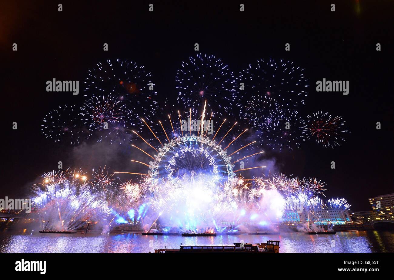 Fireworks light up the sky over the London Eye in central London during ...