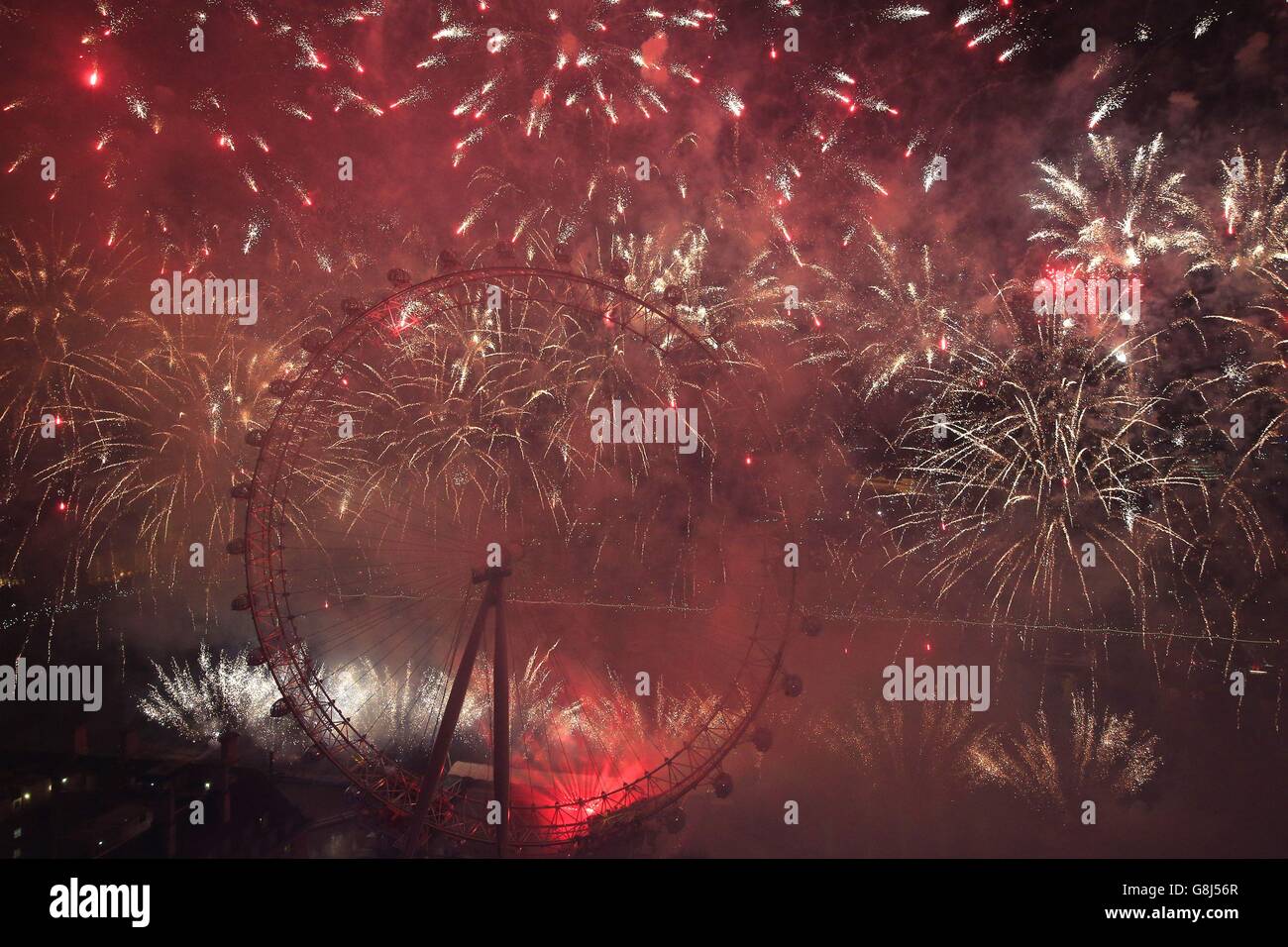 Fireworks light up the sky over the London Eye in central London during ...