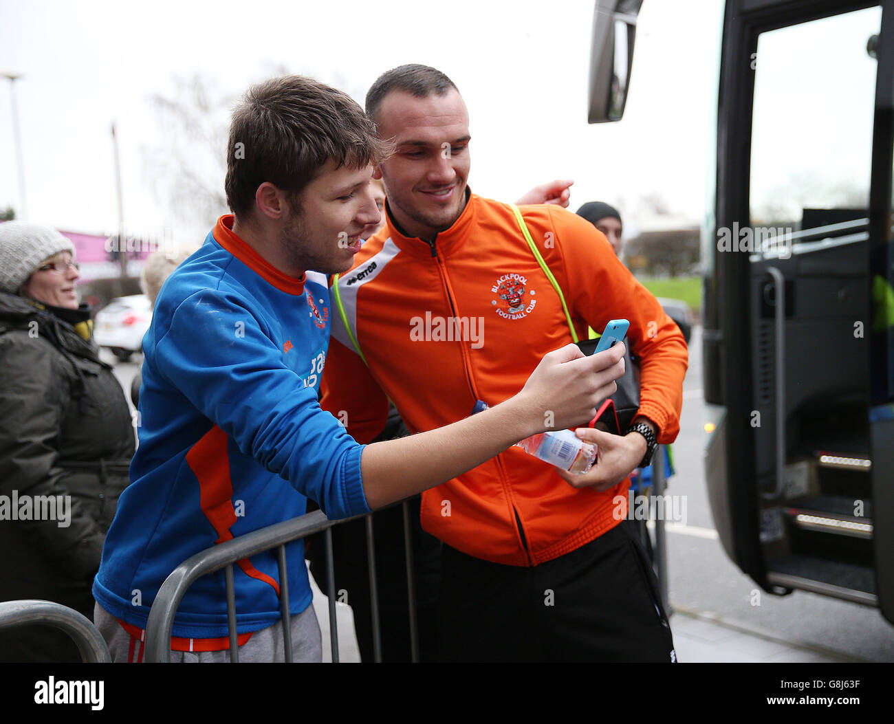 Blackpool's Tom Aldred poses for a photo with a fan before the Burton ...