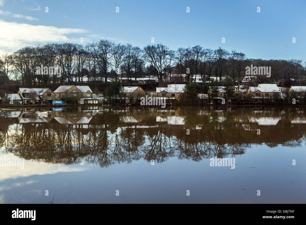Houses are reflected in flood water at dawn in Port Elphinstone, near ...