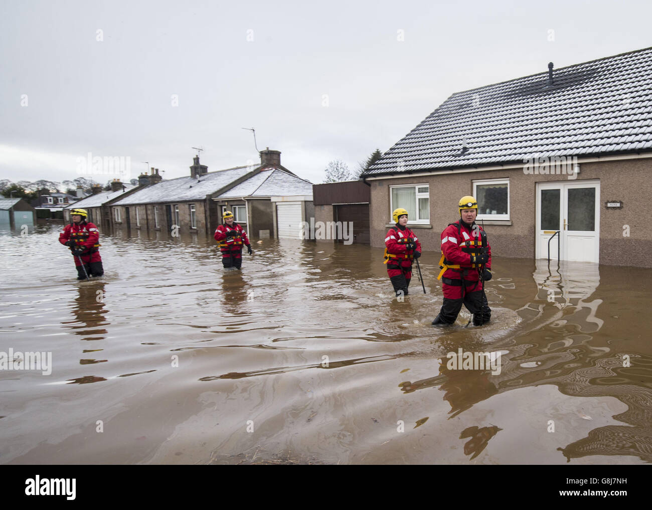 Members of the emergency services wade along Canal Road in Port ...