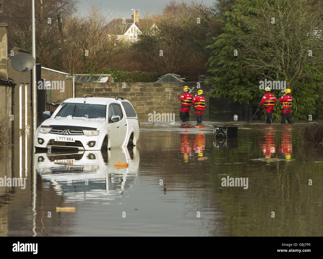 Members of the emergency services wade along Canal Road in Port ...