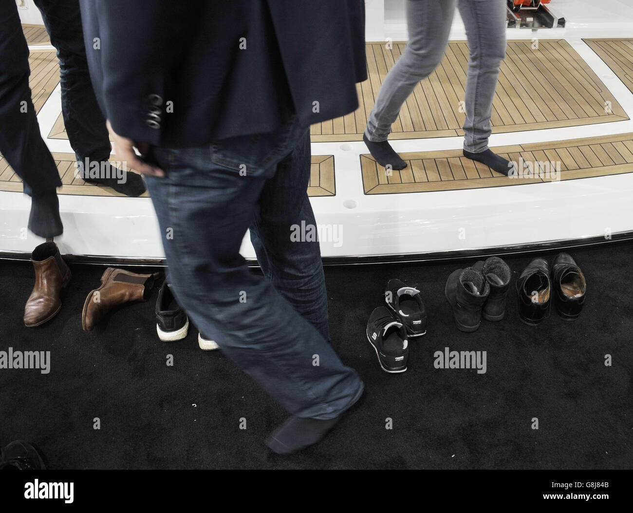 People leave their shoes as they board a Sunseeker yacht during the ...