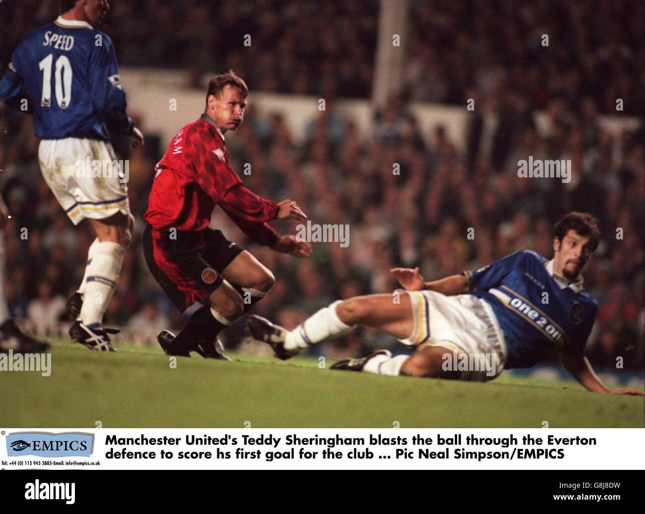 Manchester United's Teddy Sheringham (centre) blasts the ball between ...