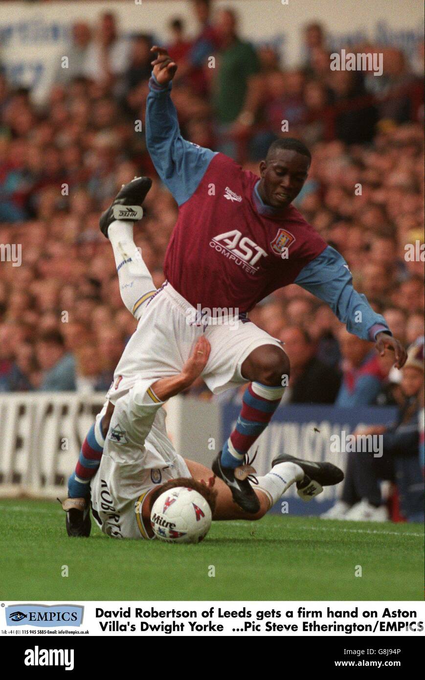 David Robertson of Leeds United (on floor) gets hold of Aston Villa's ...