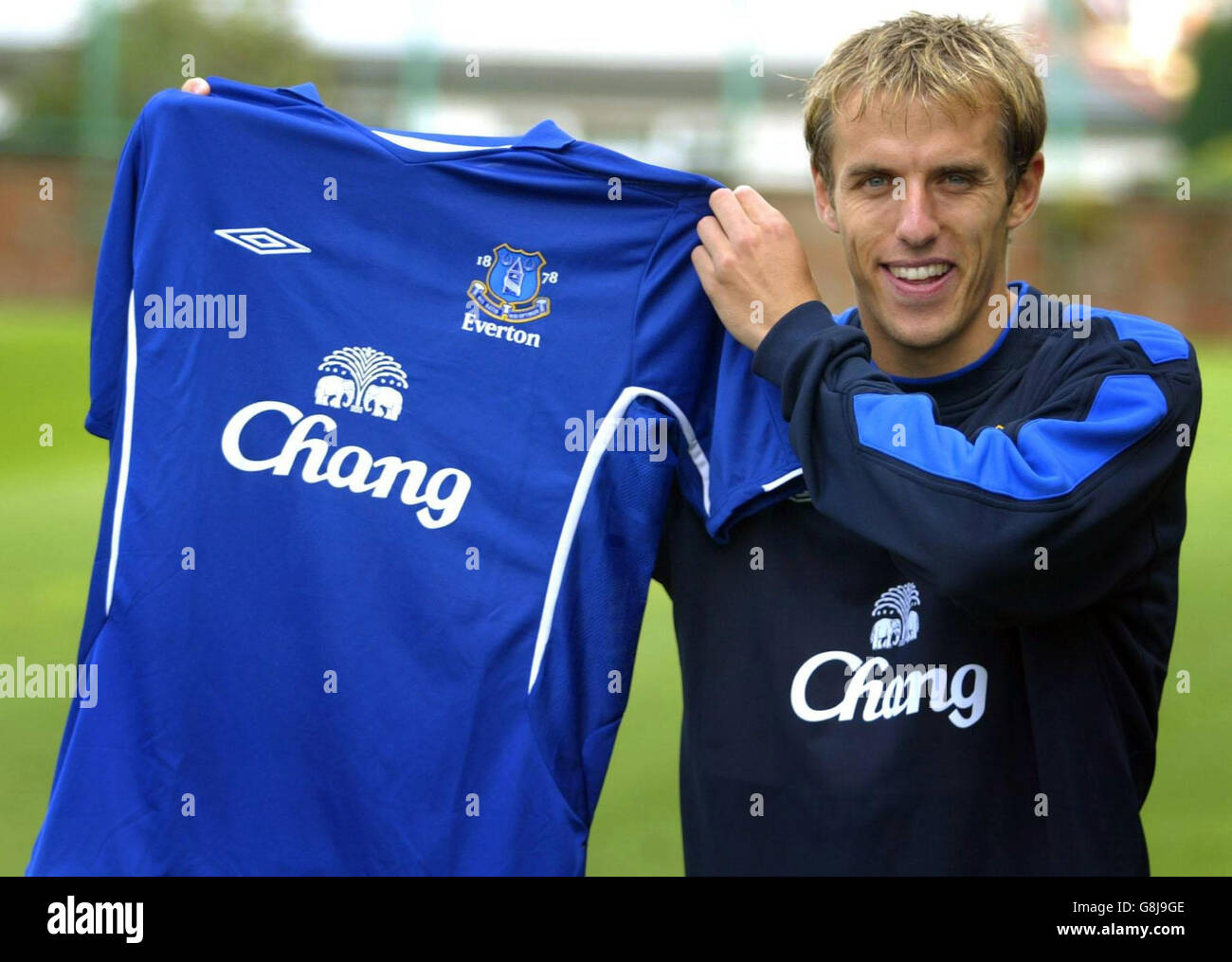Everton's new signing Phil Neville poses for photographers following a ...