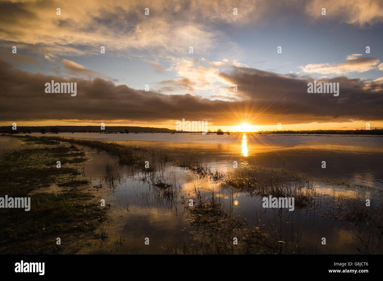 The sun rises over the flooded Somerset Levels as colder weather and ...