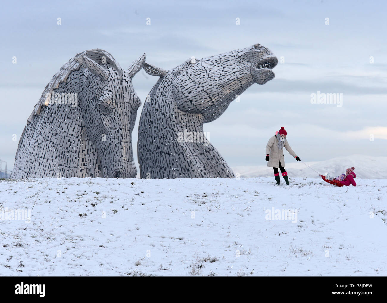 A mother and child sledge at the Kelpies in Falkirk, as a 100-mile wide ...