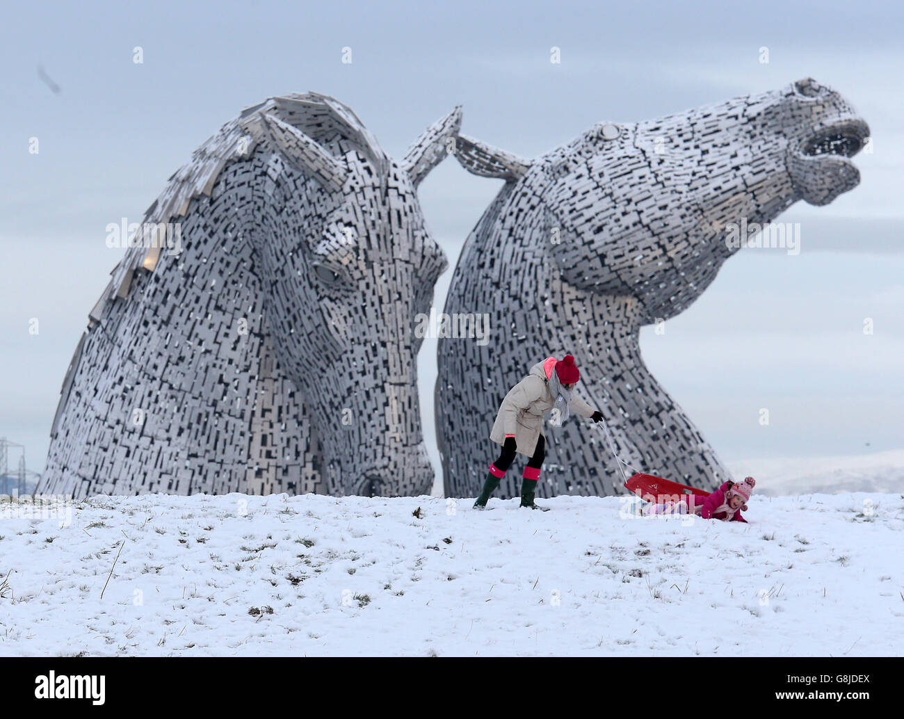 A mother and child sledge at the Kelpies in Falkirk, as a 100-mile wide ...
