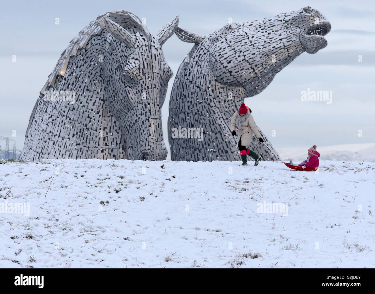 A mother and child sledge at the Kelpies in Falkirk, as a 100-mile wide ...