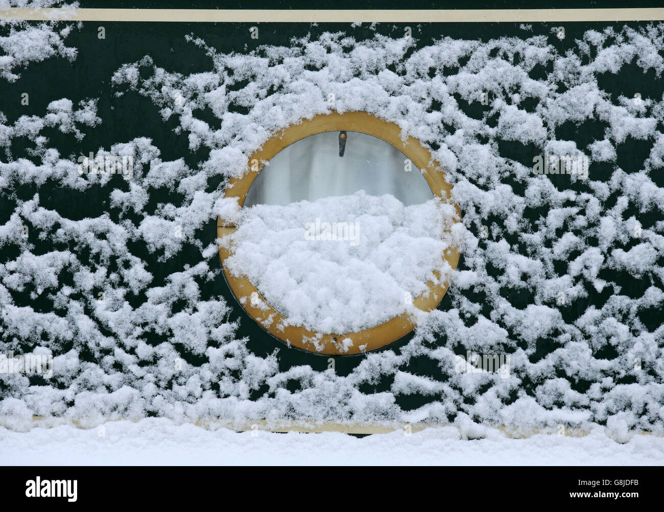 A snow covered window on a barge on the Forth and Clyde canal near the ...