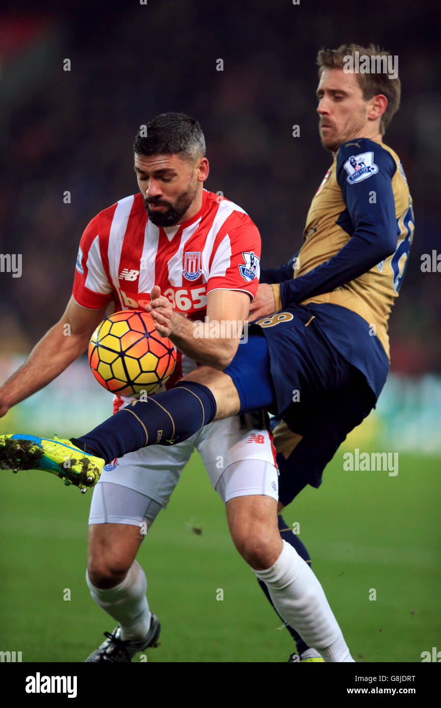 Stoke City's Jonathan Walters (left) and Arsenal's Nacho Monreal battle ...