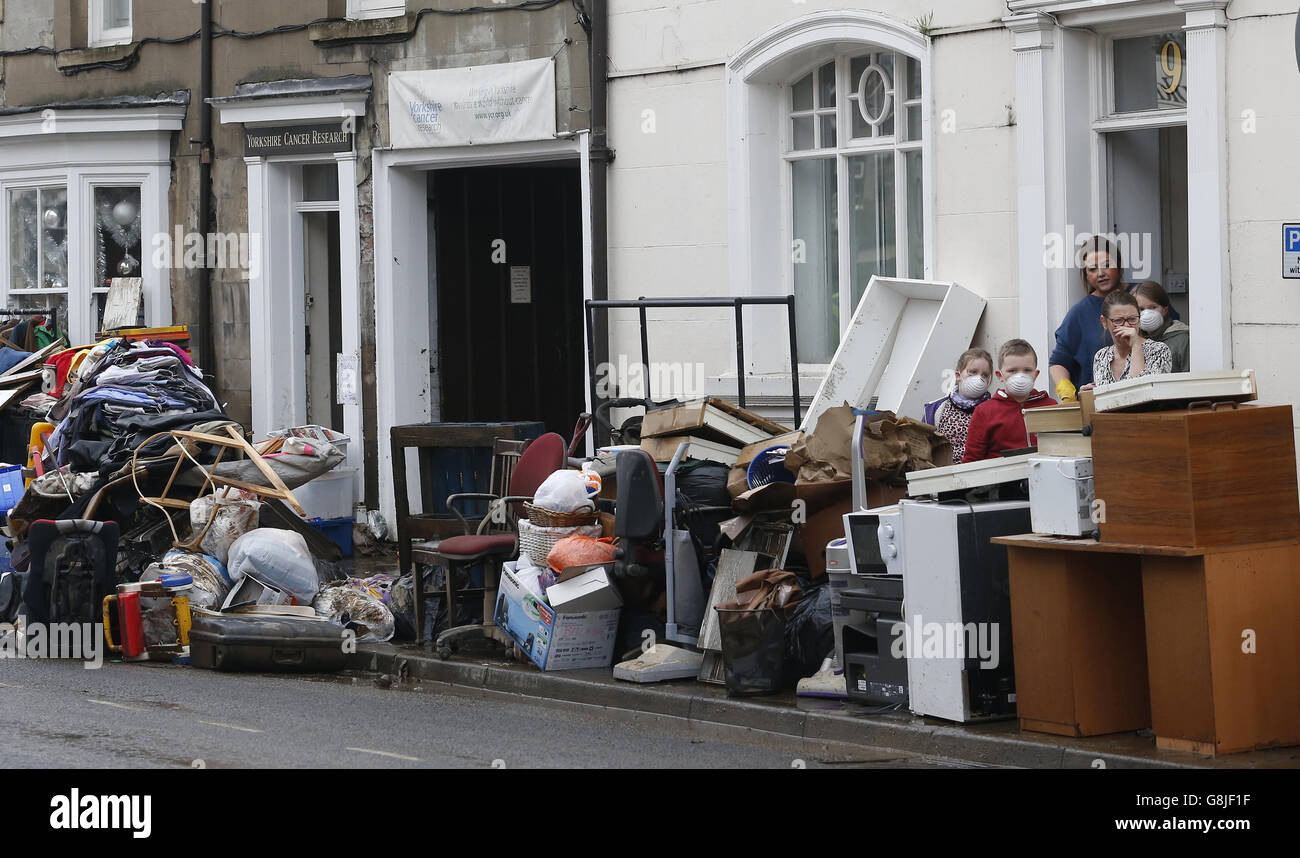 Devastated residents and shop owners clear all their belongings onto ...