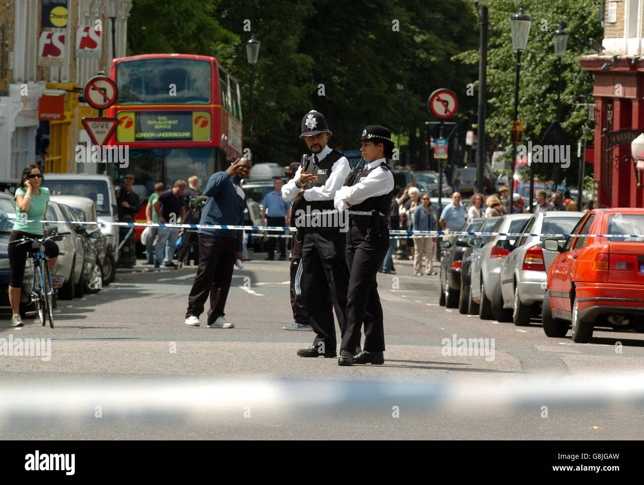 Police officers stand guard on corner lancaster road basing street hi ...