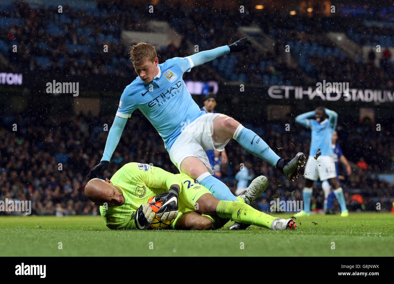 Everton goalkeeper Tim Howard saves at the feet of Manchester City's ...