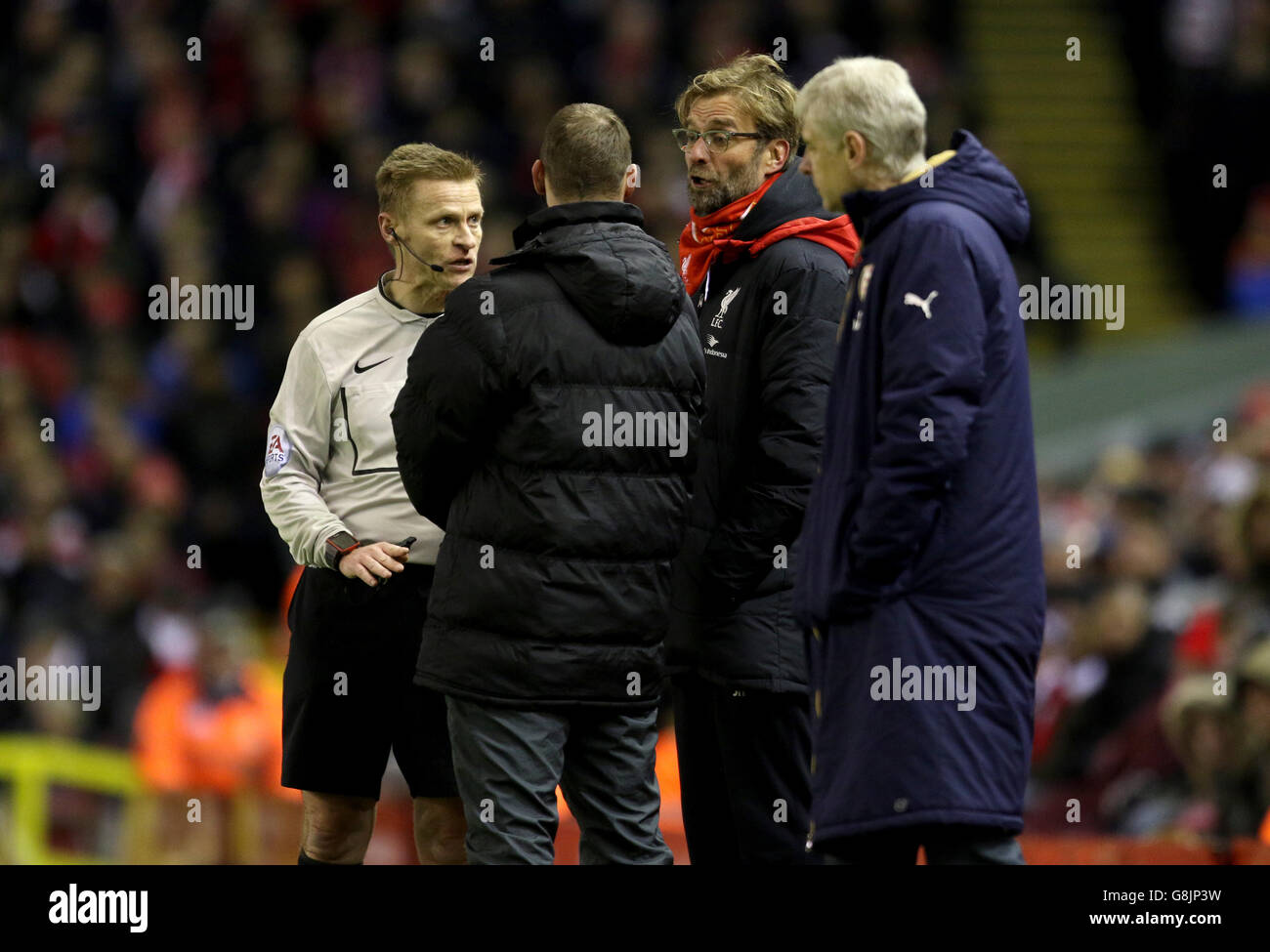 Liverpool manager Jurgen Klopp is spoken to by referee Mike Jones (left ...