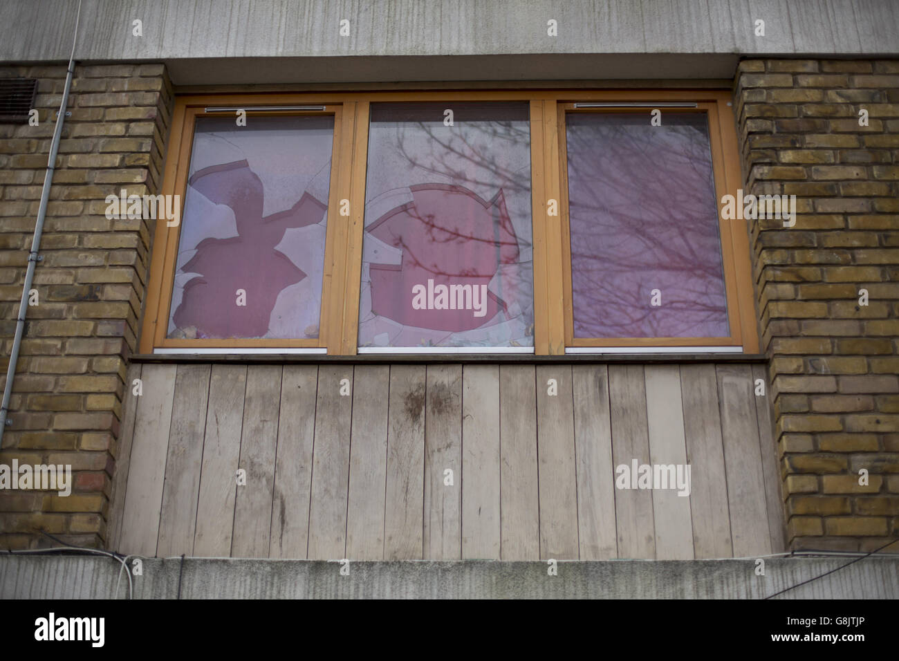 A broken window of a flat in Angell Town estate in Brixton, south ...