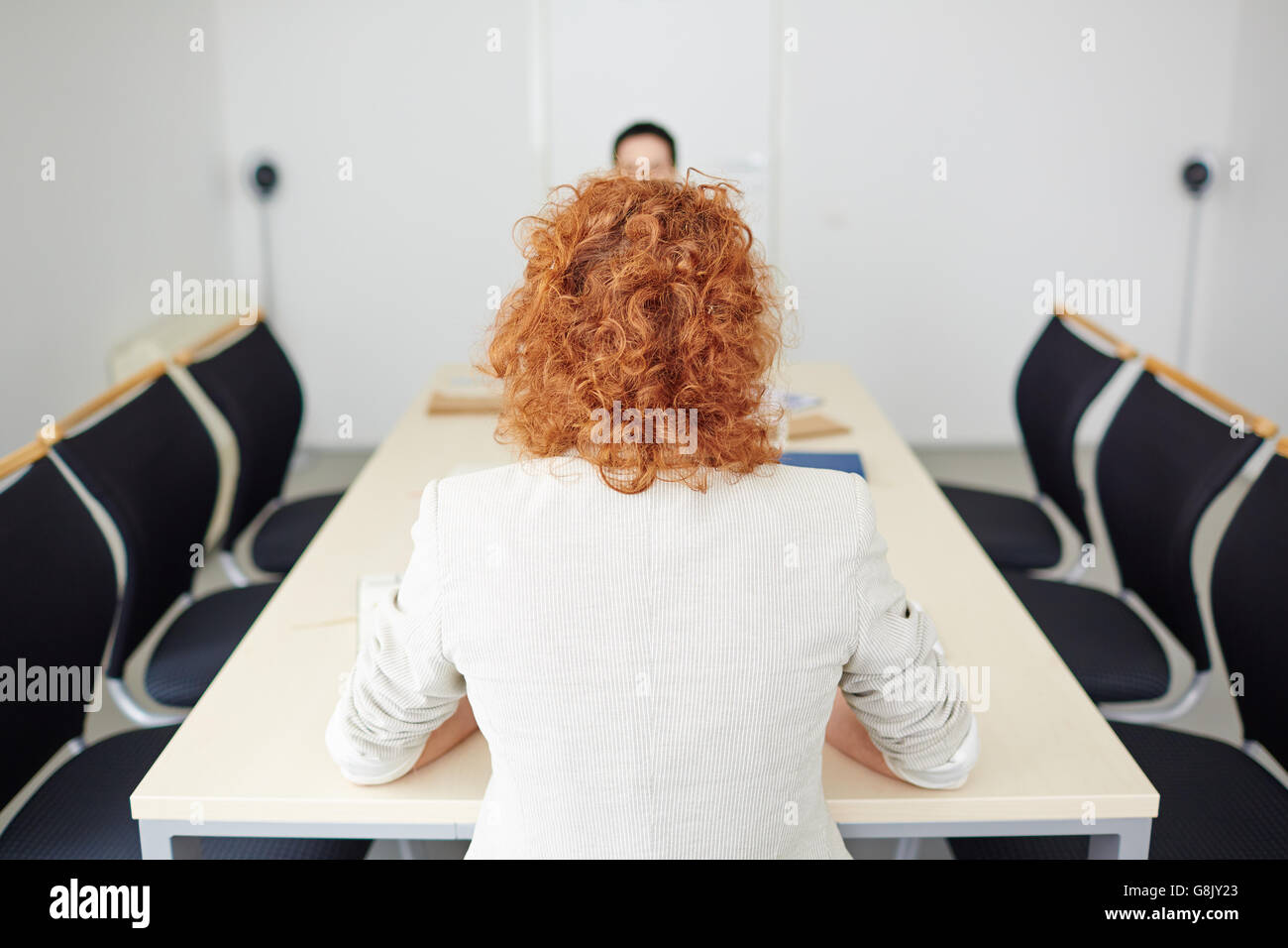 Sitting at interview Stock Photo - Alamy