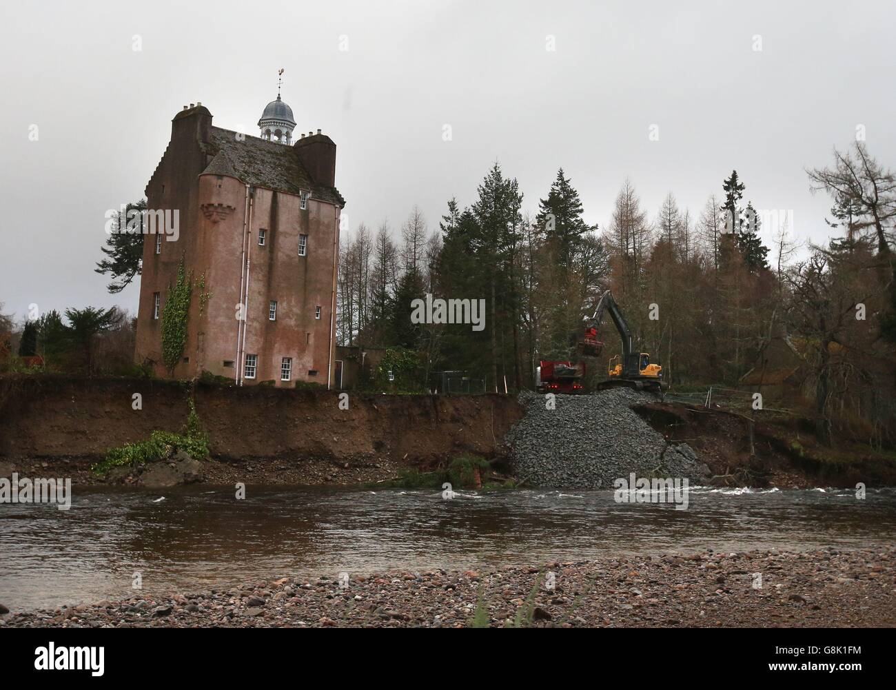 Rocks and boulders are moved to protect the shoreline on the River Dee ...