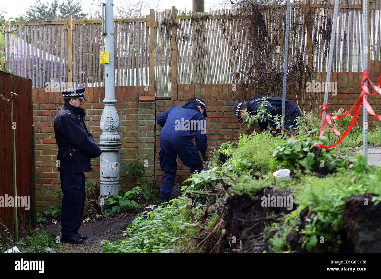 Police search officers investigate an alleyway next to the house in ...