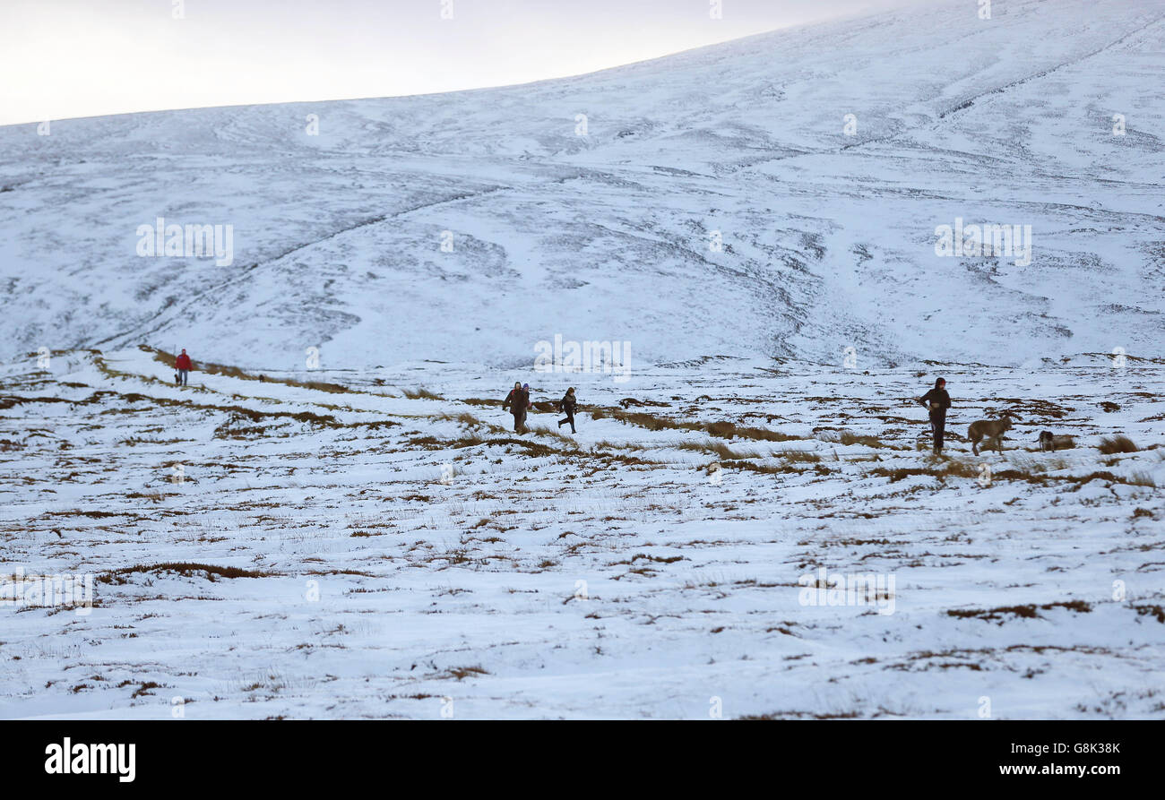 People walk through snow covered fields in Killakee in Dublin as ...