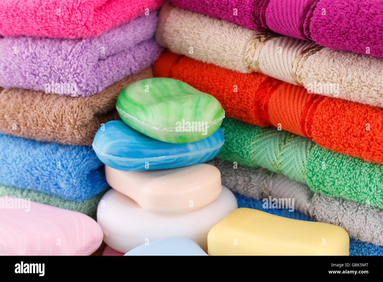Colorful towels stacks and soaps closeup picture Stock Photo - Alamy