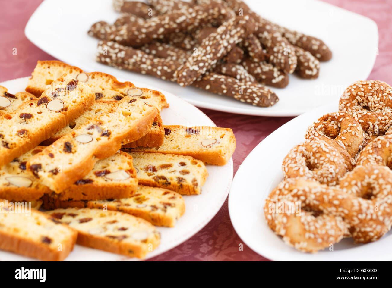 Different crackers in plates on pink cloth background Stock Photo - Alamy