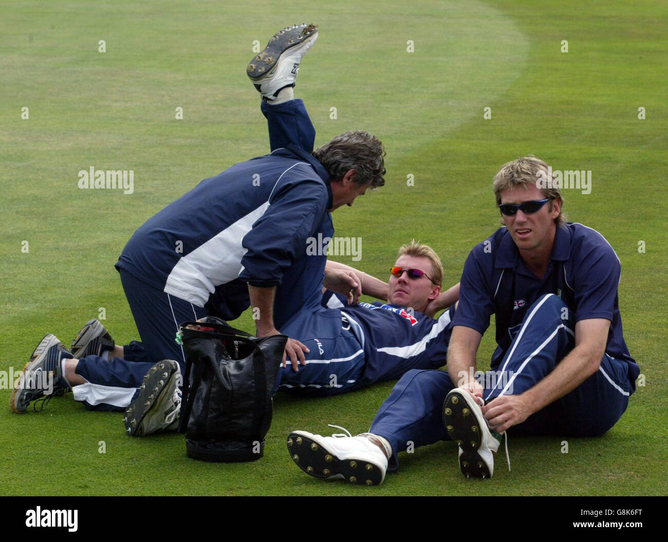 Australia's Glenn McGrath (R) with Brett Lee under the watchfull eye of ...