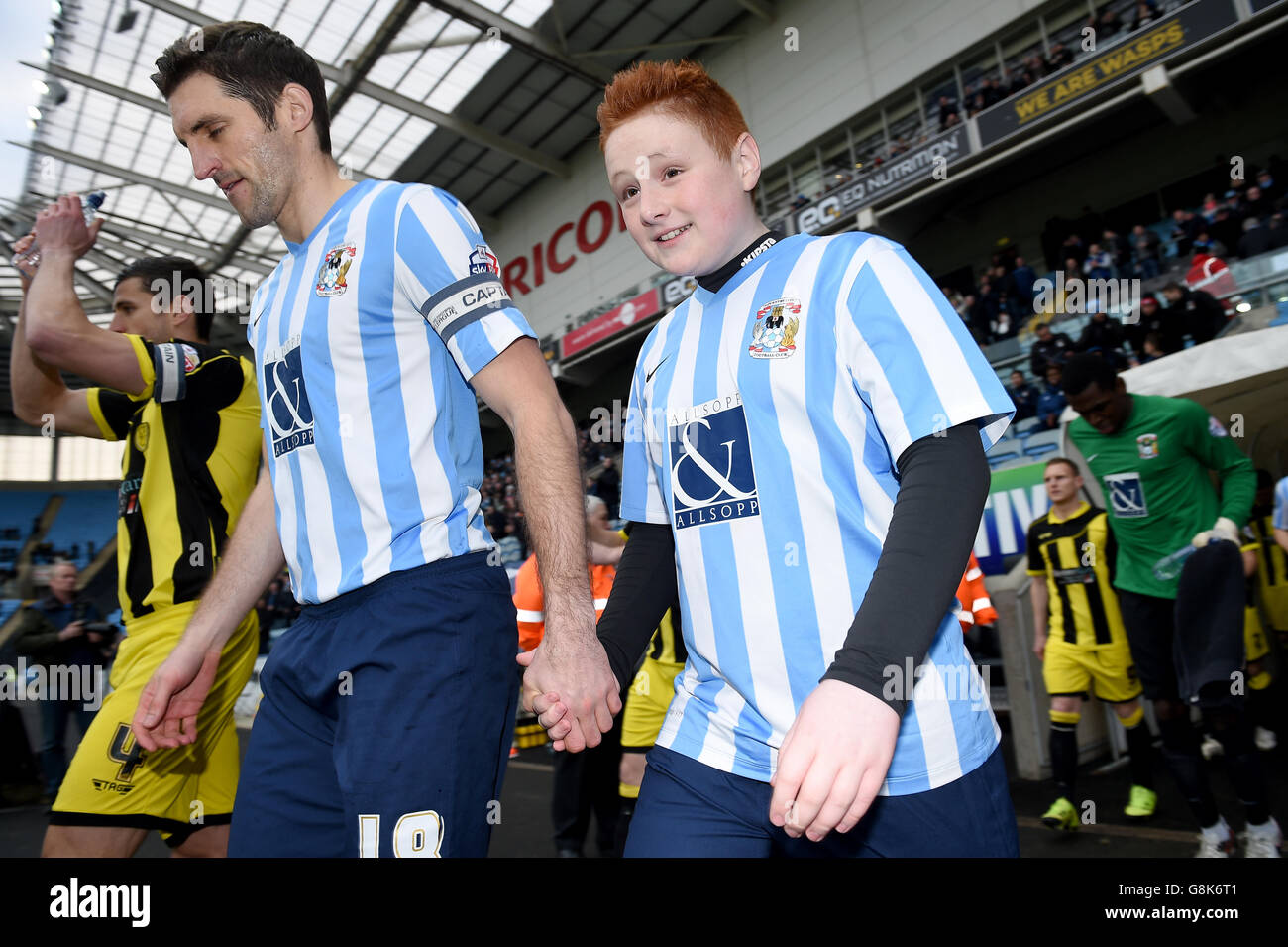 Coventry City's Sam Ricketts walks out with a match day mascot before ...
