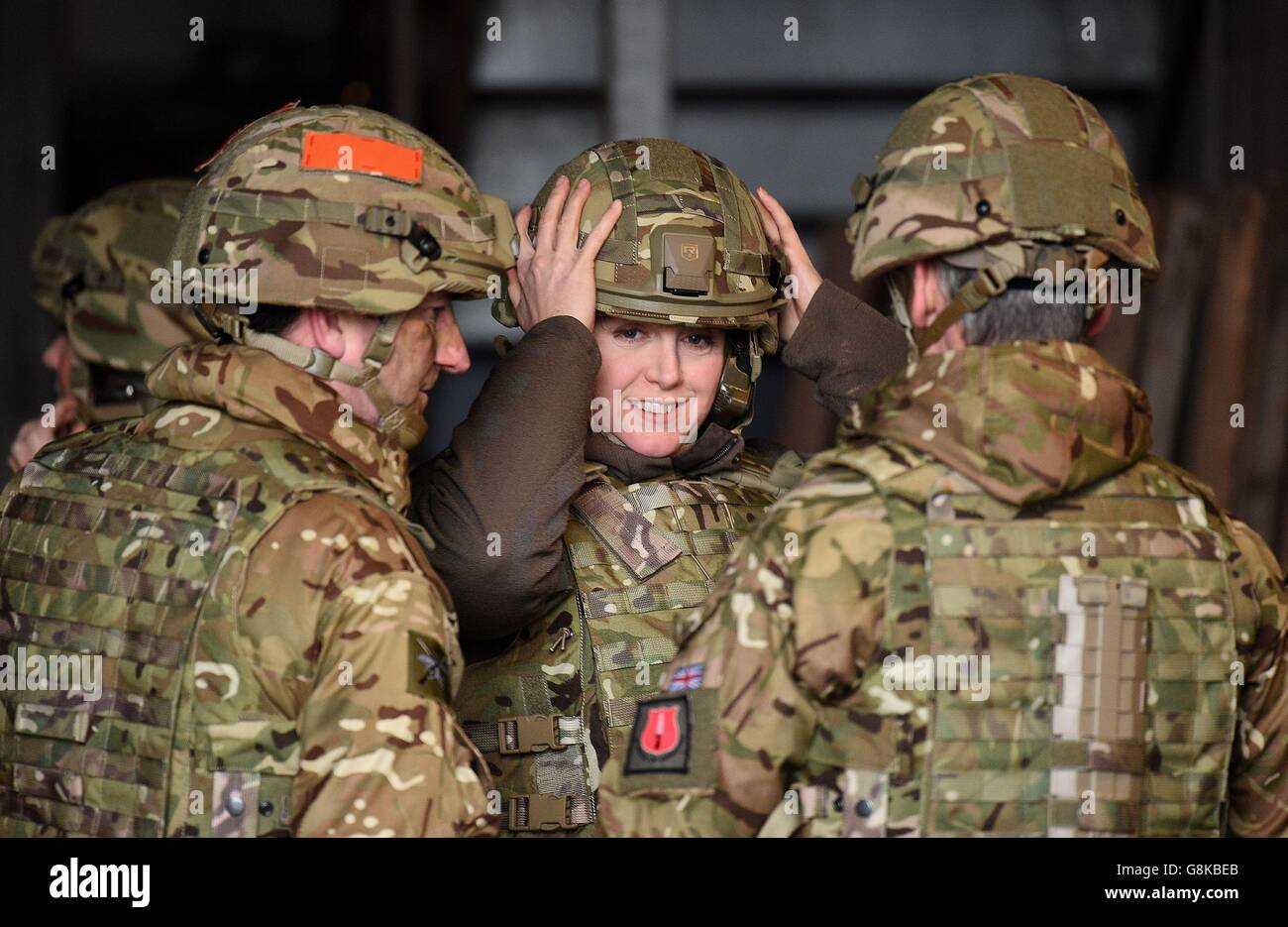 Armed Forces Minister Penny Mordaunt adjusts her helmet before watching ...