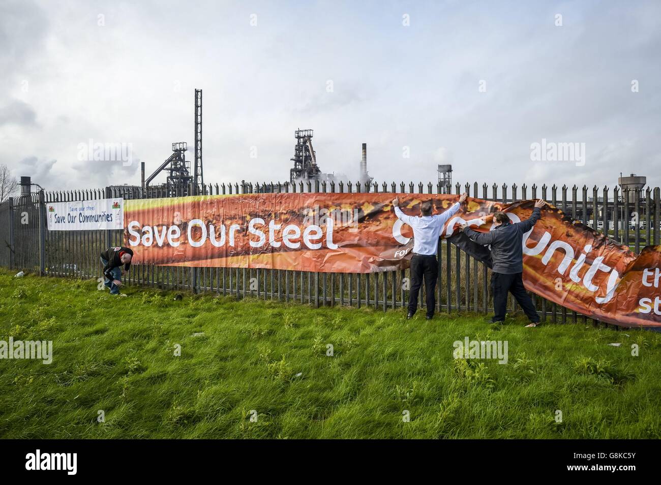 Workers erect a "Save Our Steel" banner on the fence outside the Tata ...