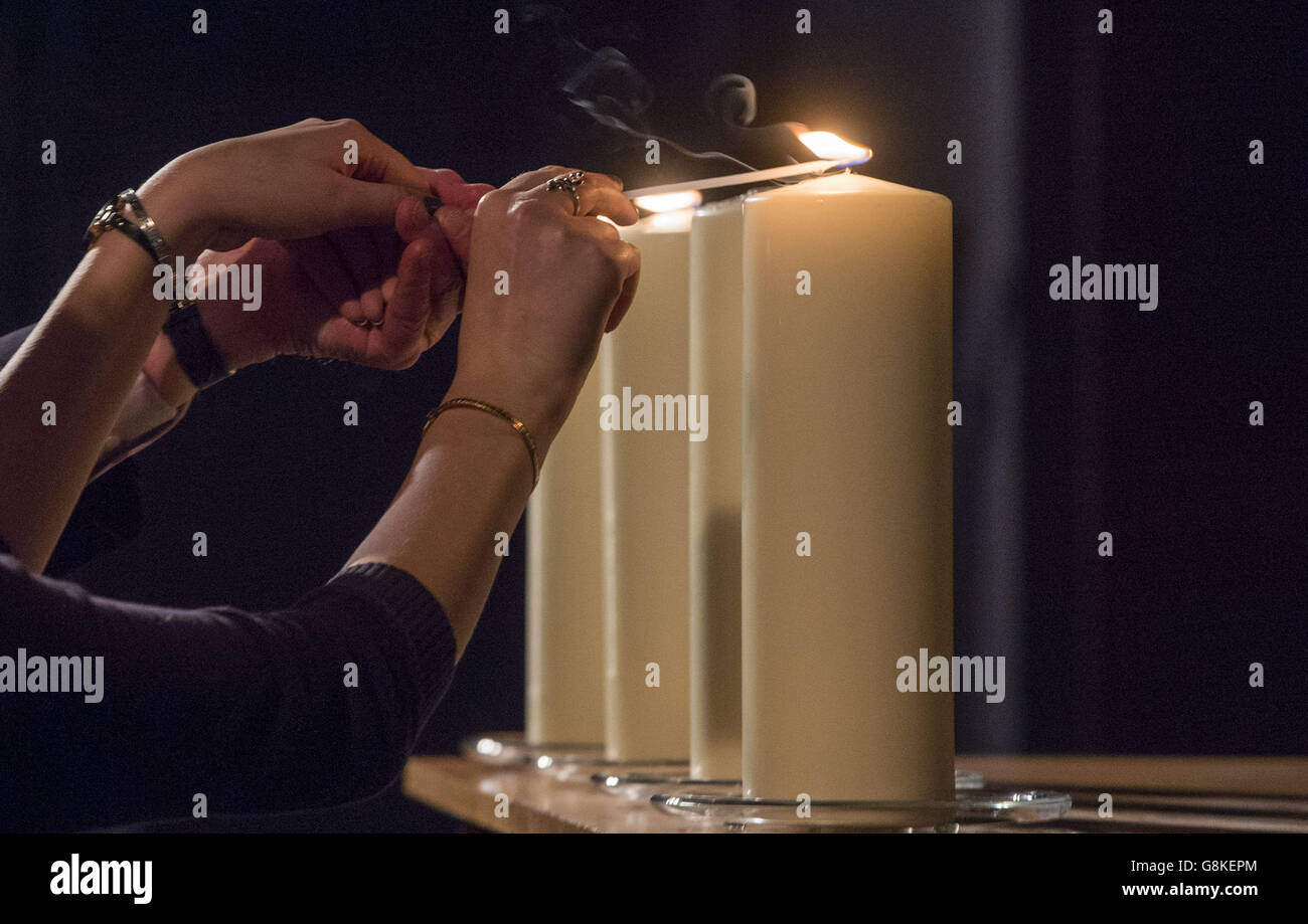 Holocaust survivor Jan Imich and his daughter light a memorial candle ...