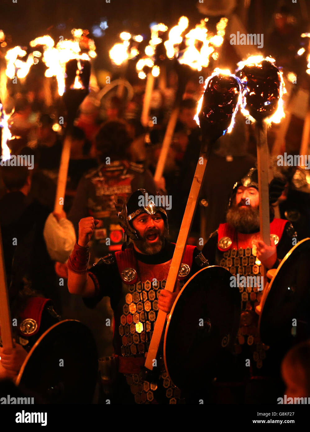Members of the Jarl Squad dressed in Viking costumes carry flaming ...