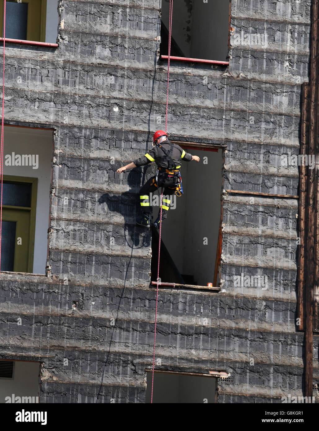 climbers of firefighters climbing a wall of a house during the fire ...