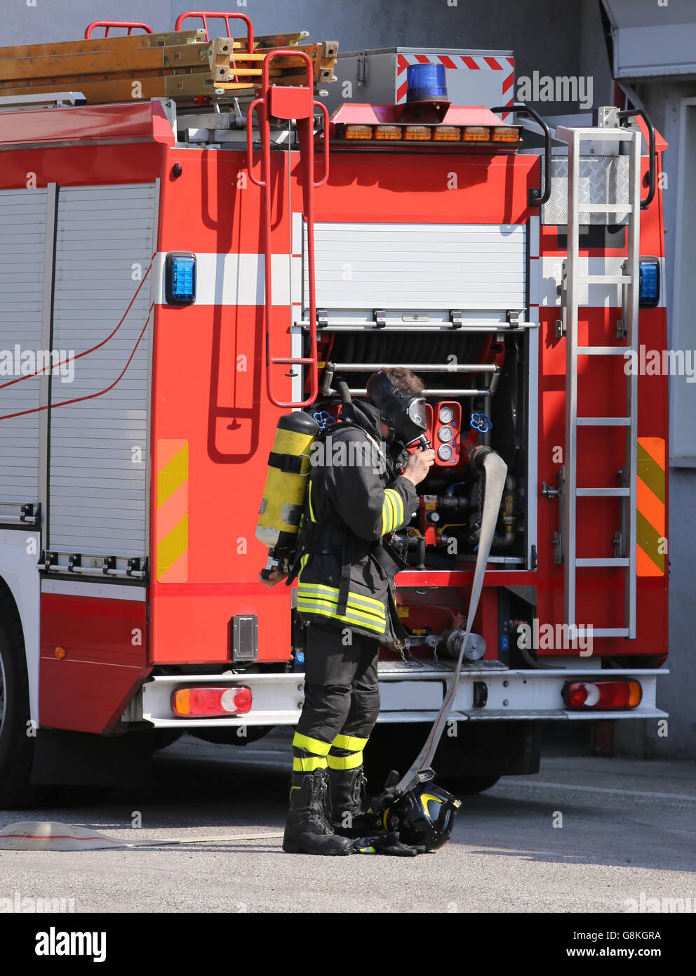 brave firefighters with fire engine truck during an exercise in fire ...