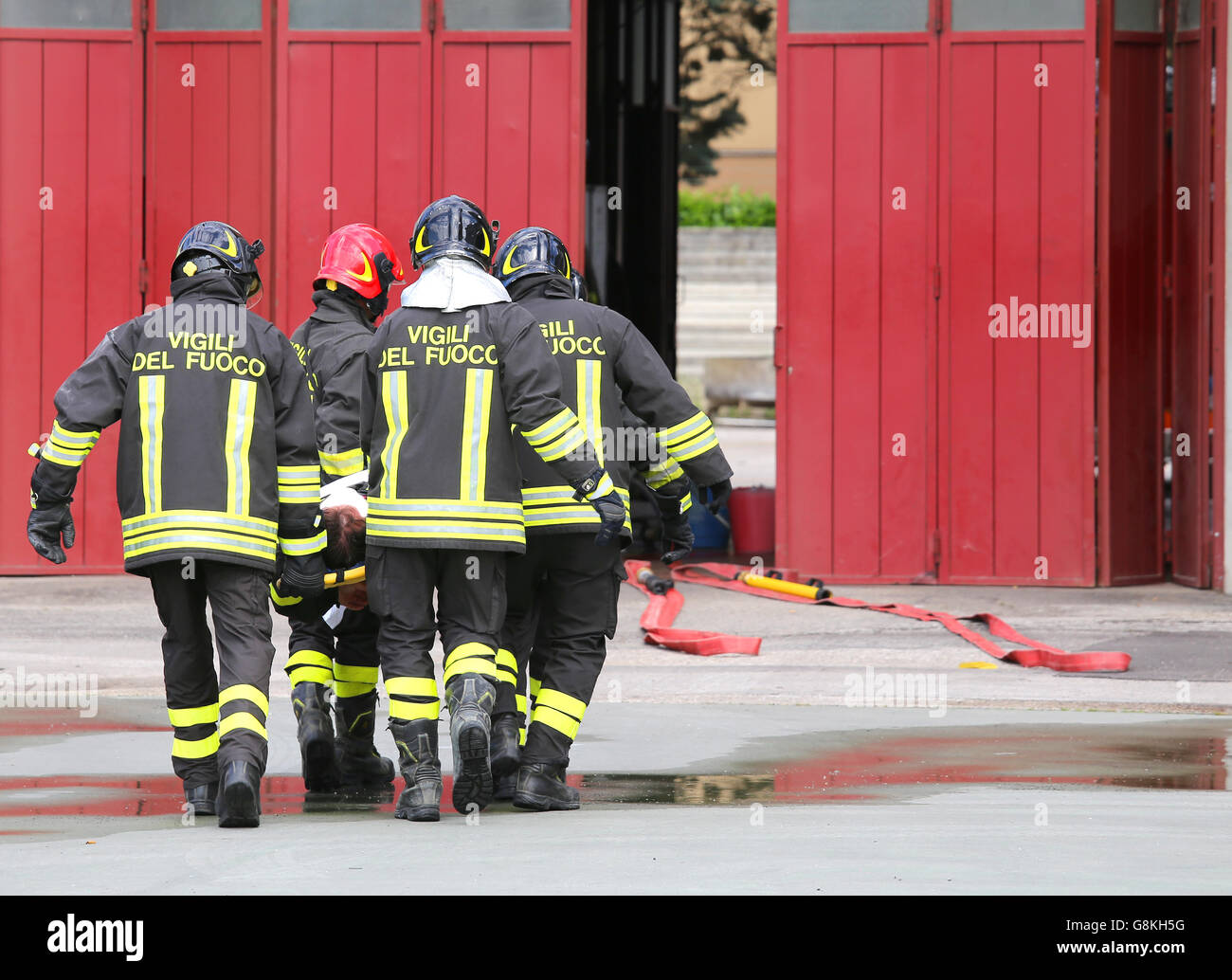wounded carried by firefighters on a stretcher after the road accident ...