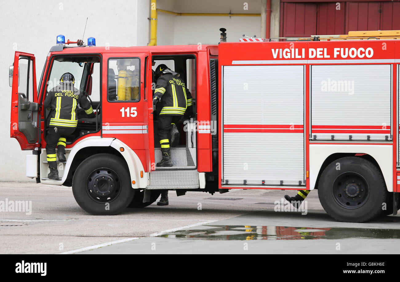 fire engine carrying firefighters and equipment for fighting fire Stock ...
