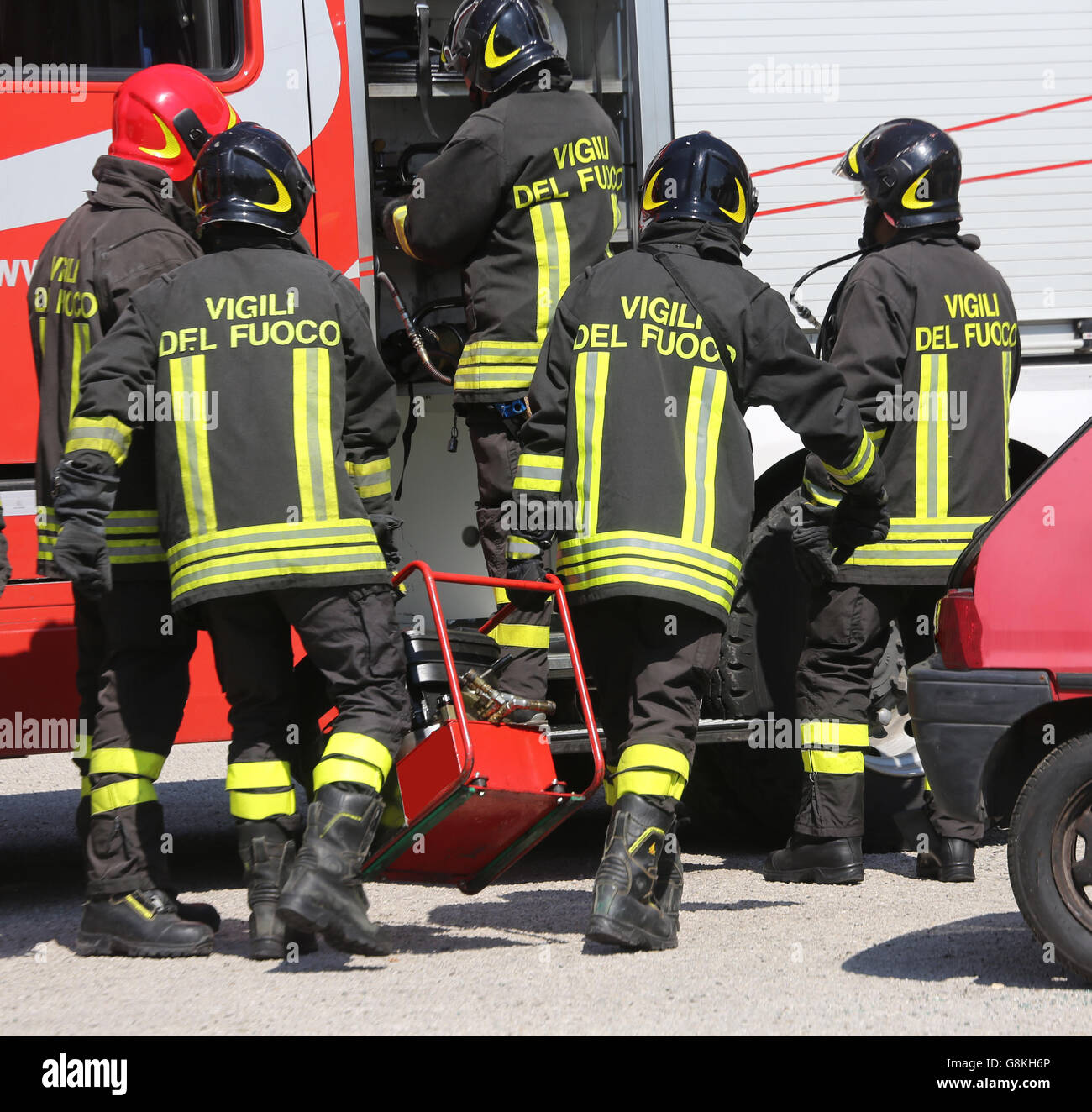 Group of firefighters working as a perfect teamwork during an emergency ...