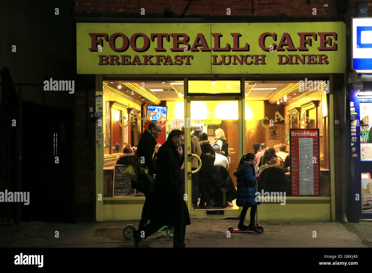 Fans walk past the football cafe on their way to Vicarage Road before ...