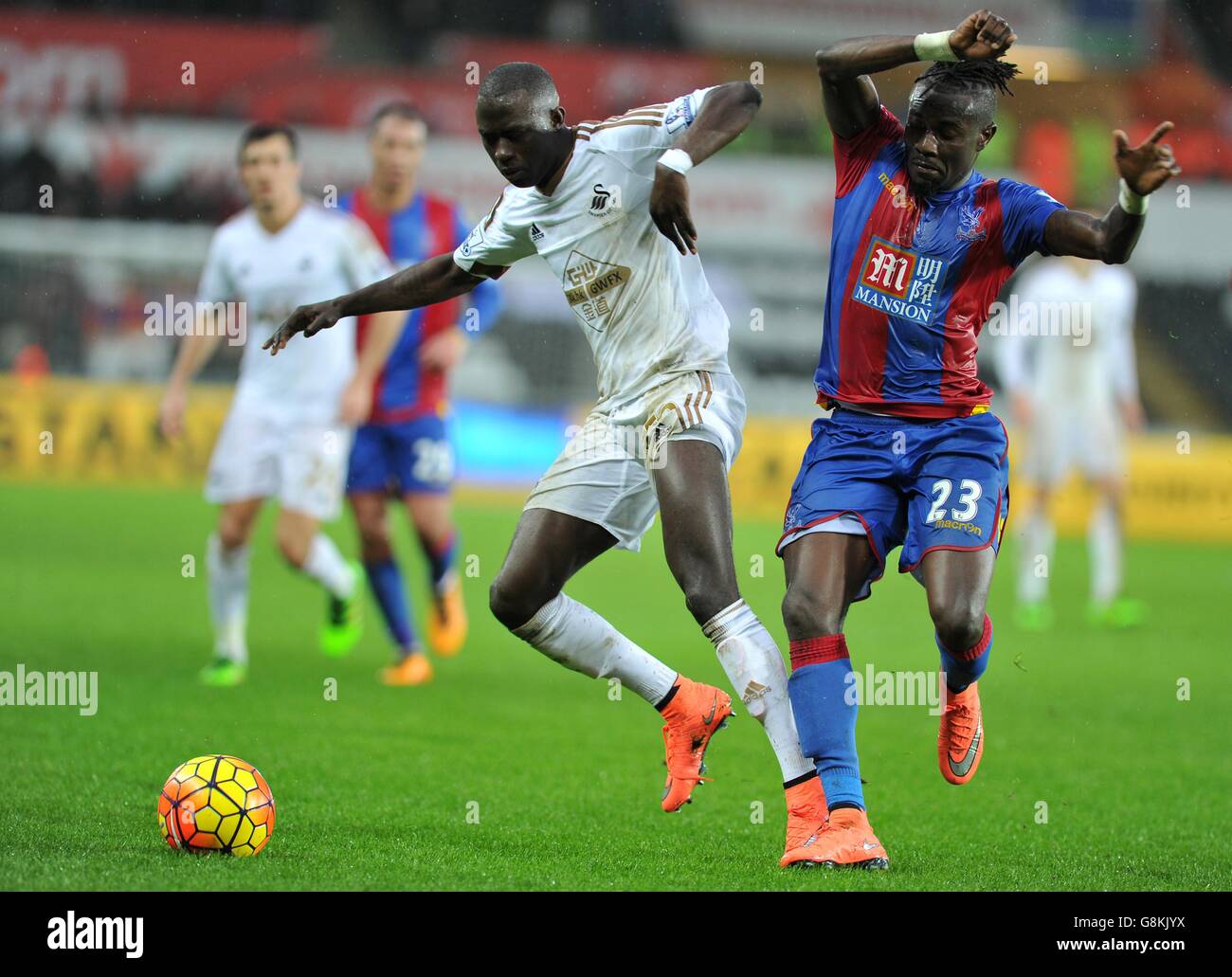 Swansea City's Modou Barrow (left) and Crystal Palace's Pape Souare ...