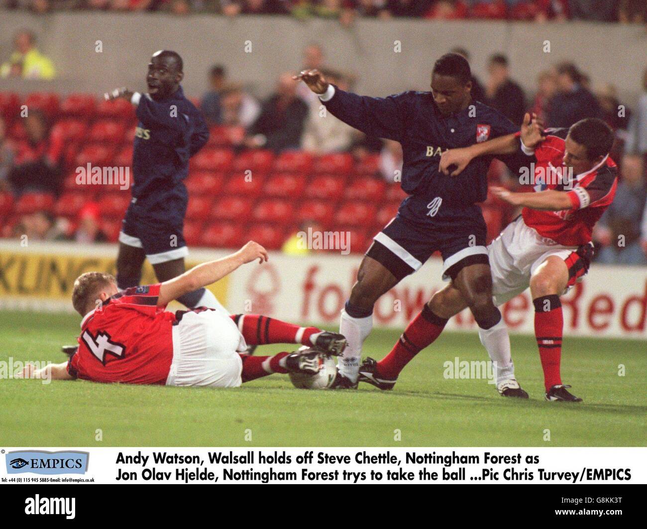 Andy Watson of Walsall (centre) holds off Steve Chettle of Nottingham ...