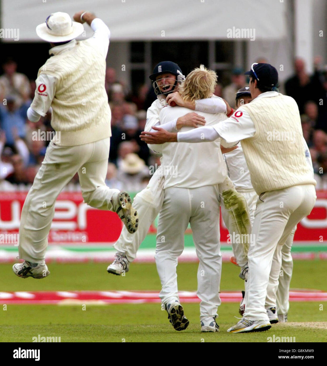 England bowler Matthew Hoggard embraces team-mate Ian Bell (centre left ...