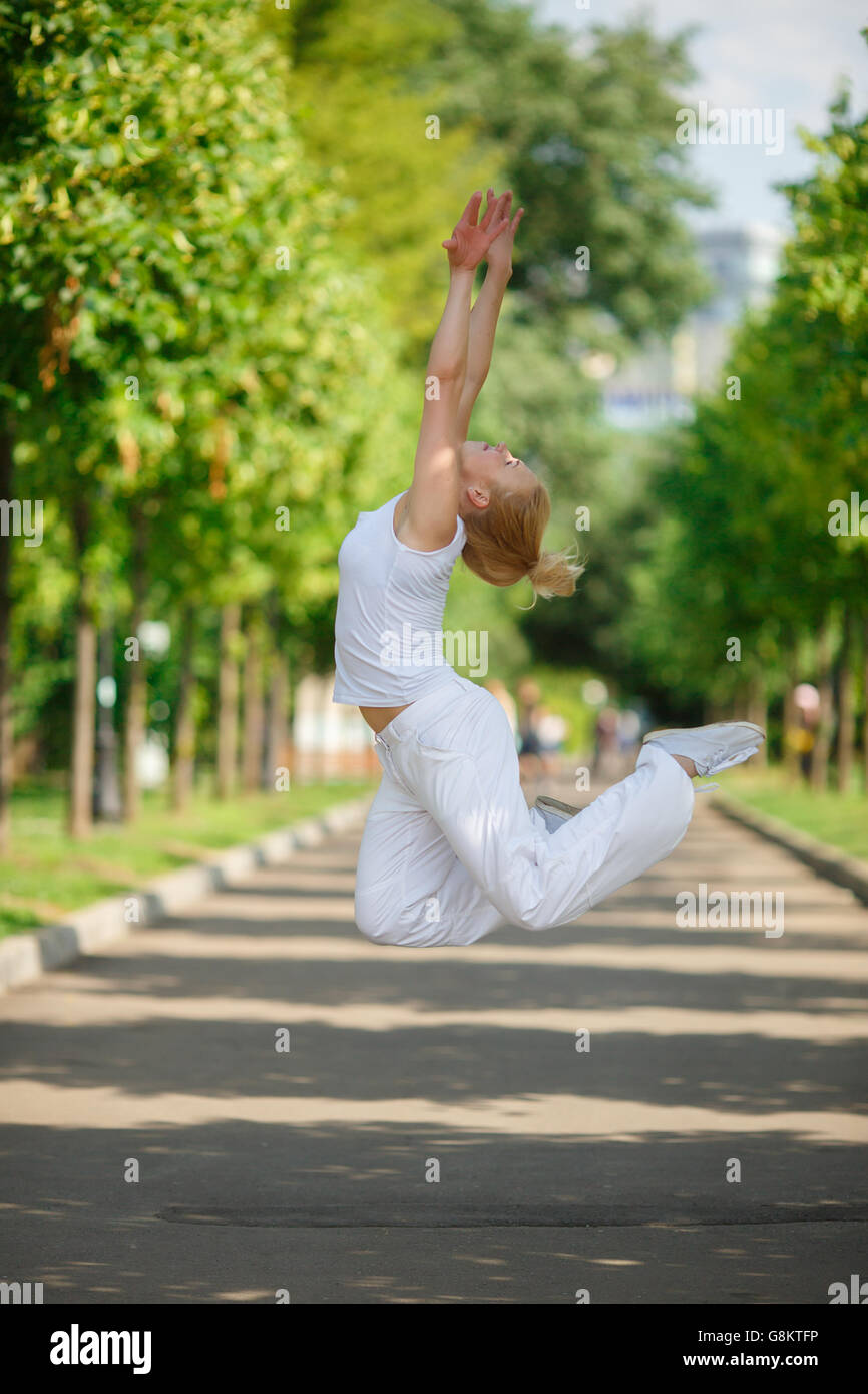 Woman jumping with hands up Stock Photo - Alamy