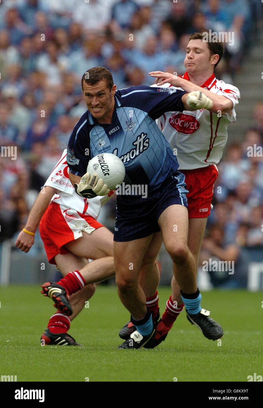 Dublin's Ciaran Whelan (left) is tackled by Tyrone's Enda McGinley ...