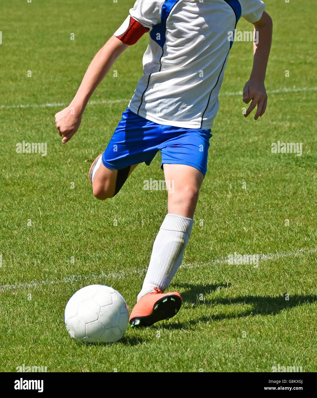 Young soccer player kicks the ball Stock Photo - Alamy