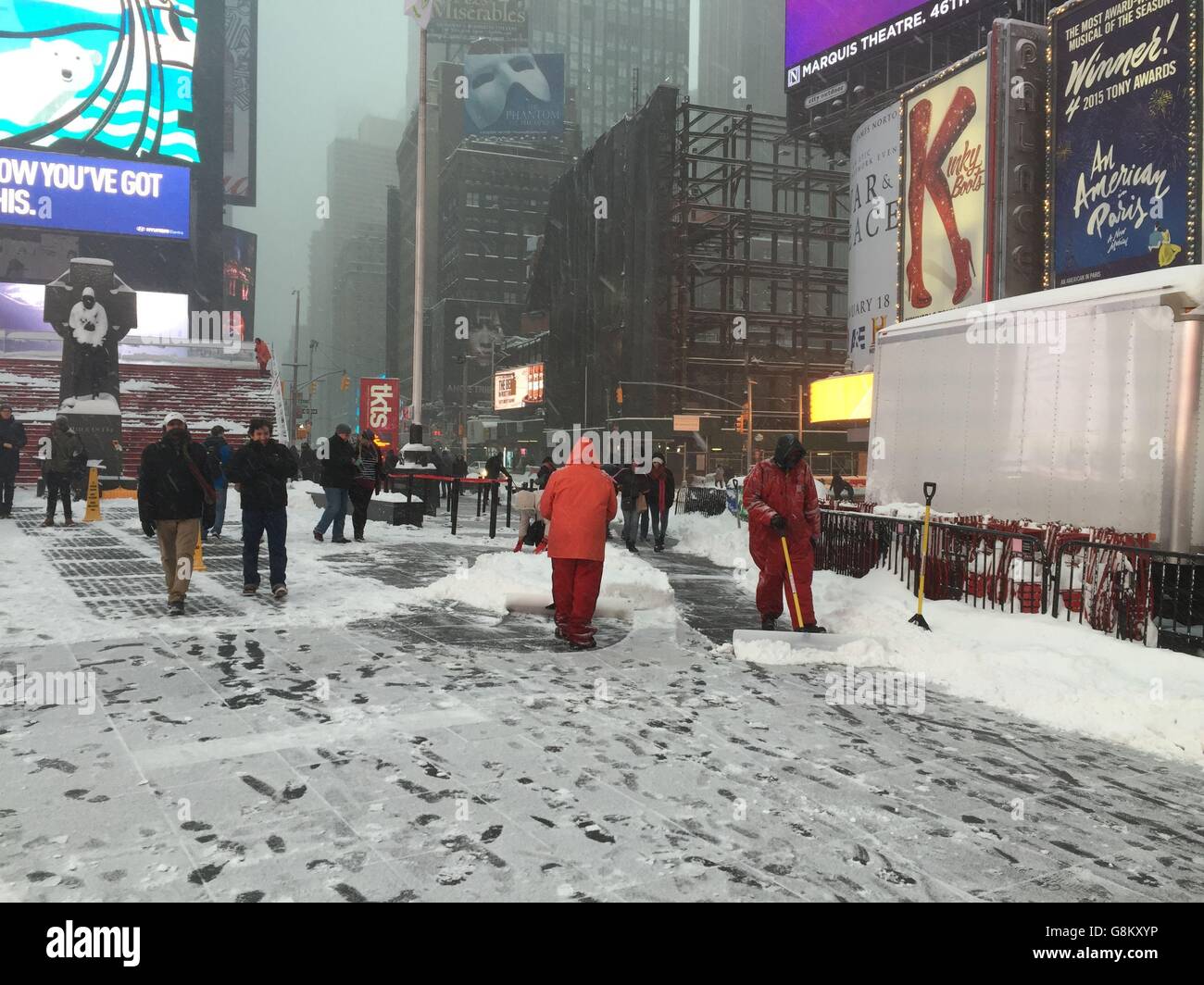Locals and tourists in New York City battle the weather during a ...