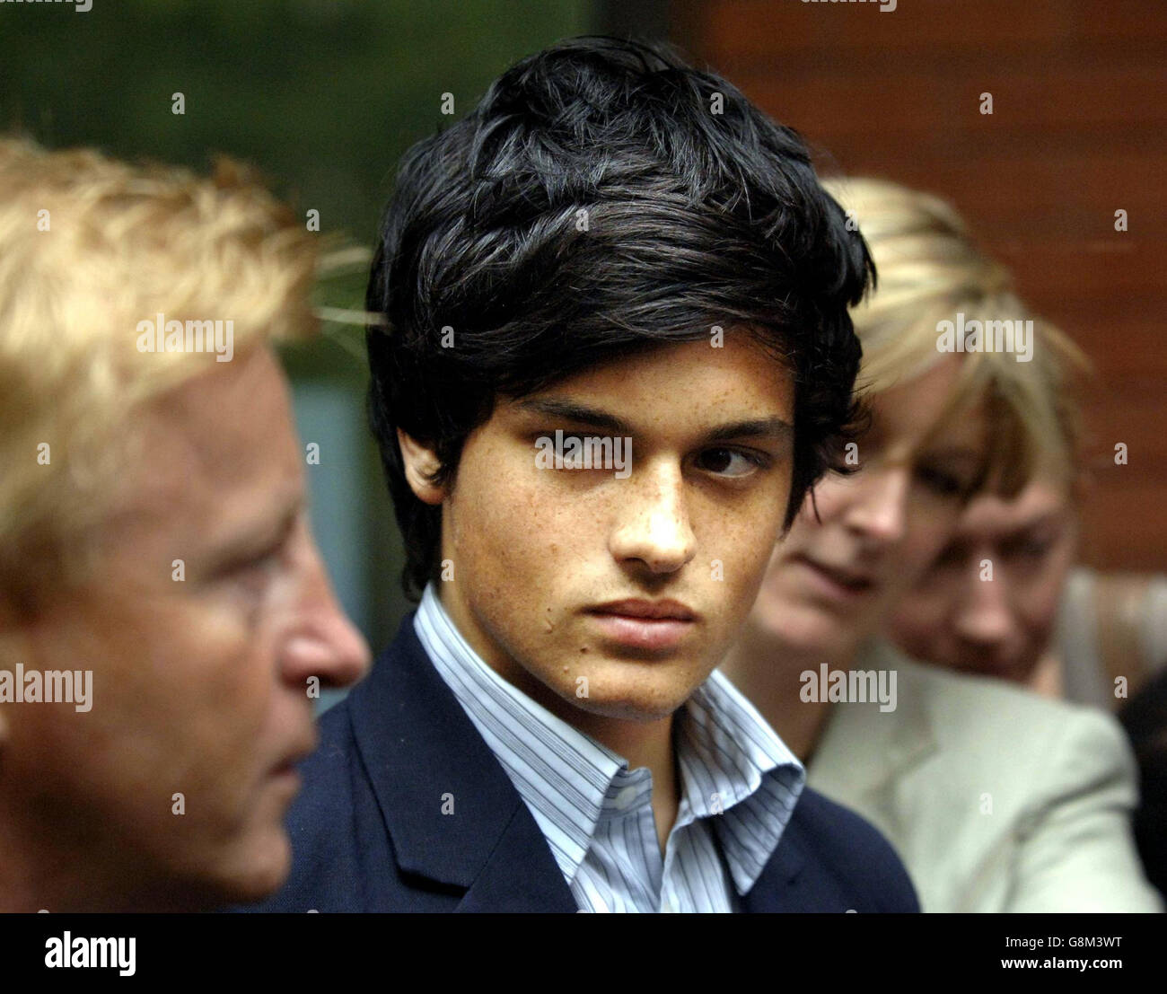Rhys Gray (centre), 15, listens to his father Russell Gray (left ...
