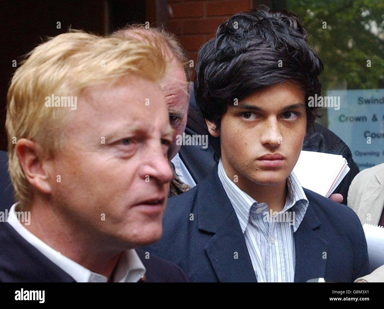 Rhys Gray, 15, listens to his father Russell Gray (left) speaking to ...